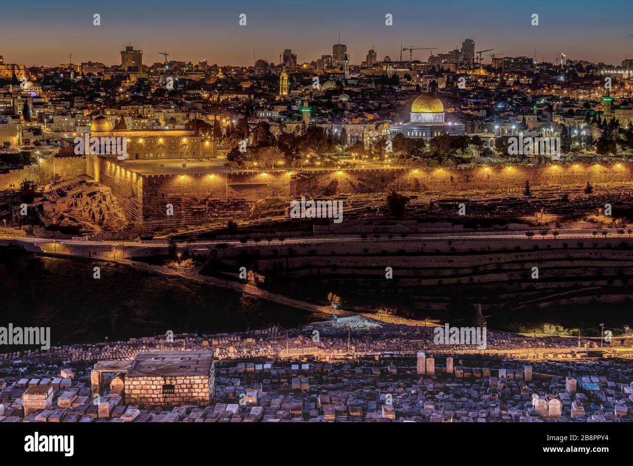 The city skyline illuminated at night from the Mount of Olives ...