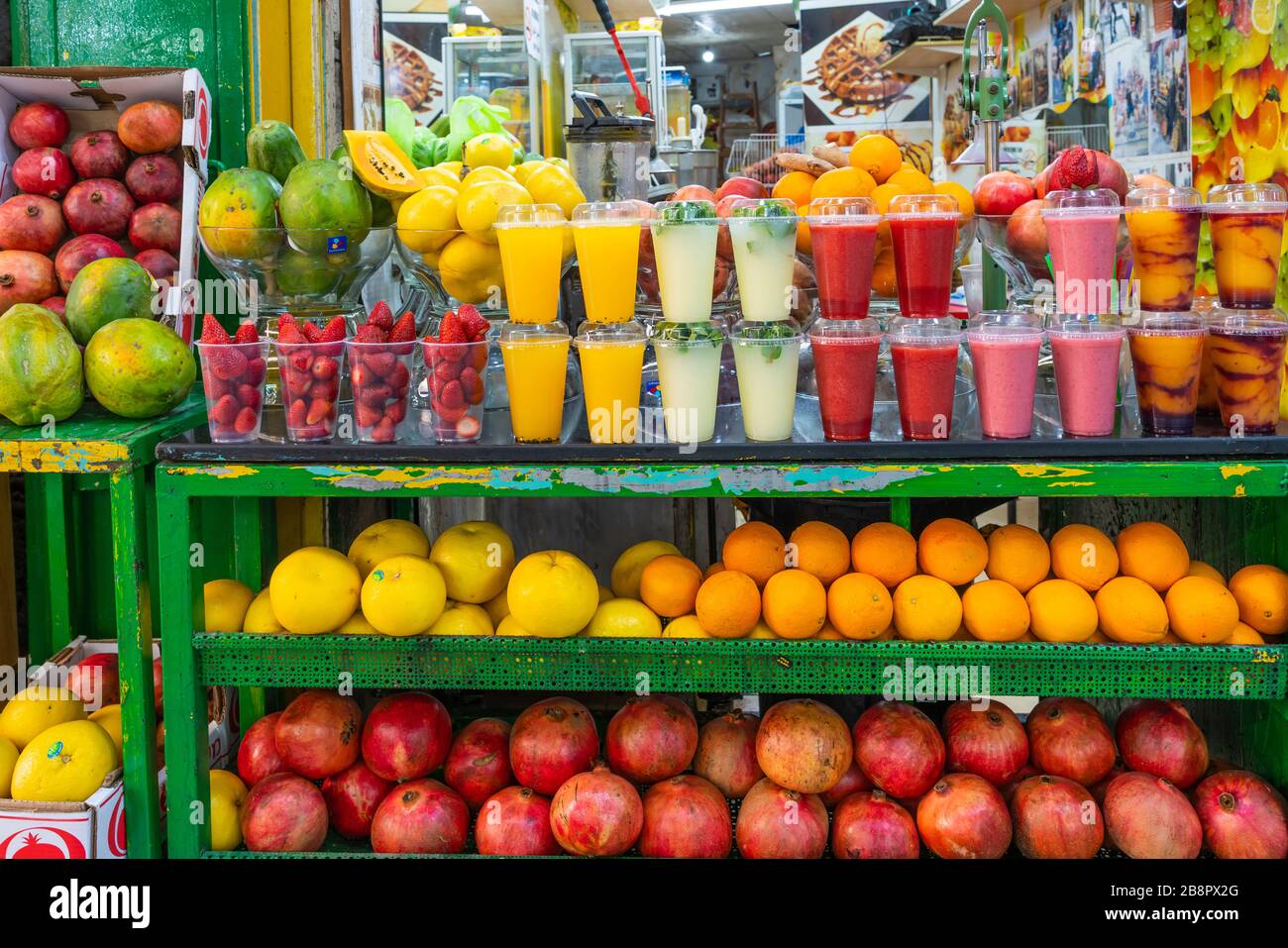 A colorful fruit stand selling fruit juices in the old city of ...