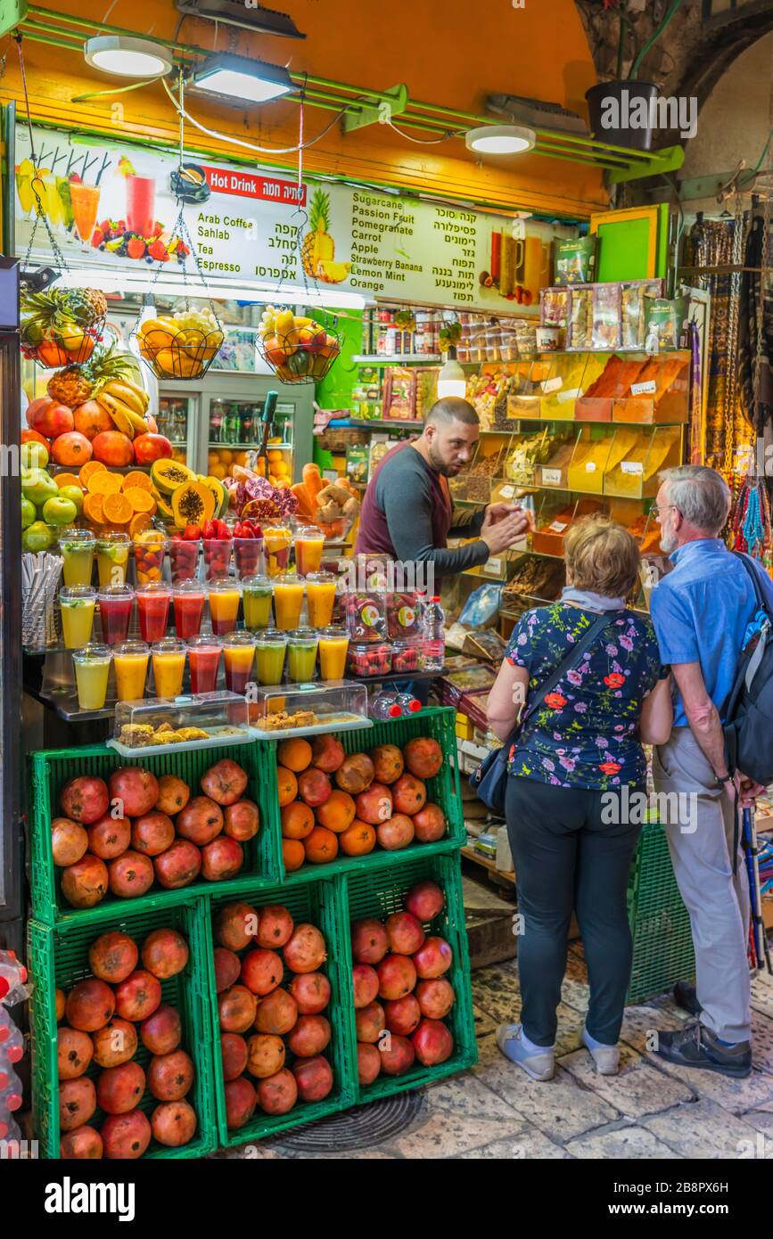 A colorful fruit stand selling fruit juices in the old city of ...