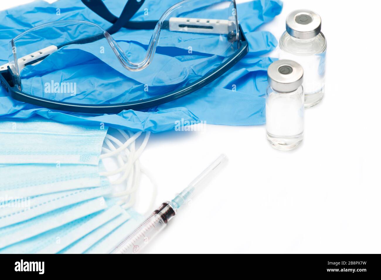 Face masks, gloves, safety glasses, syringe and medication vials ...