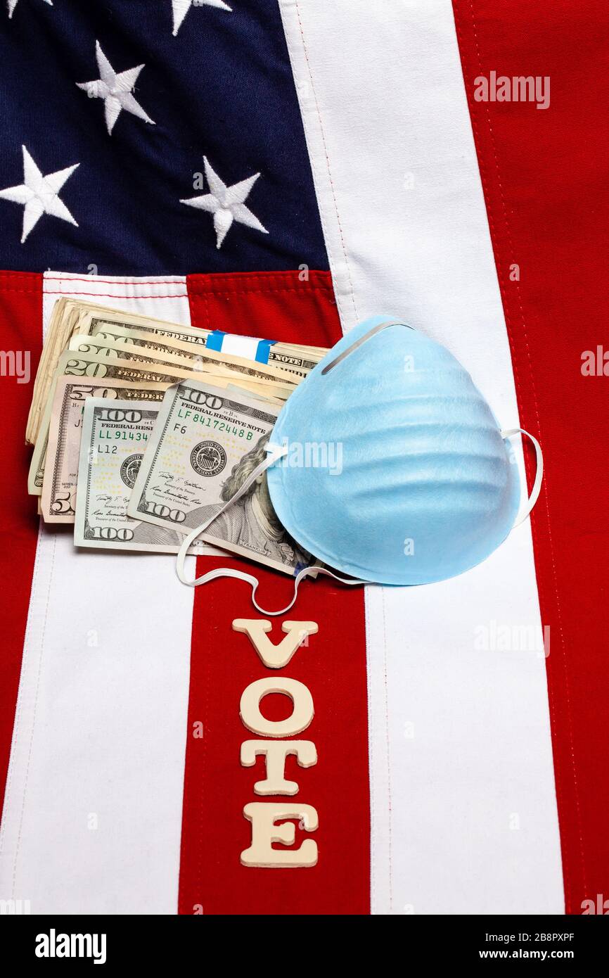 Respirator mask with cash money and the words vote in front of the ...