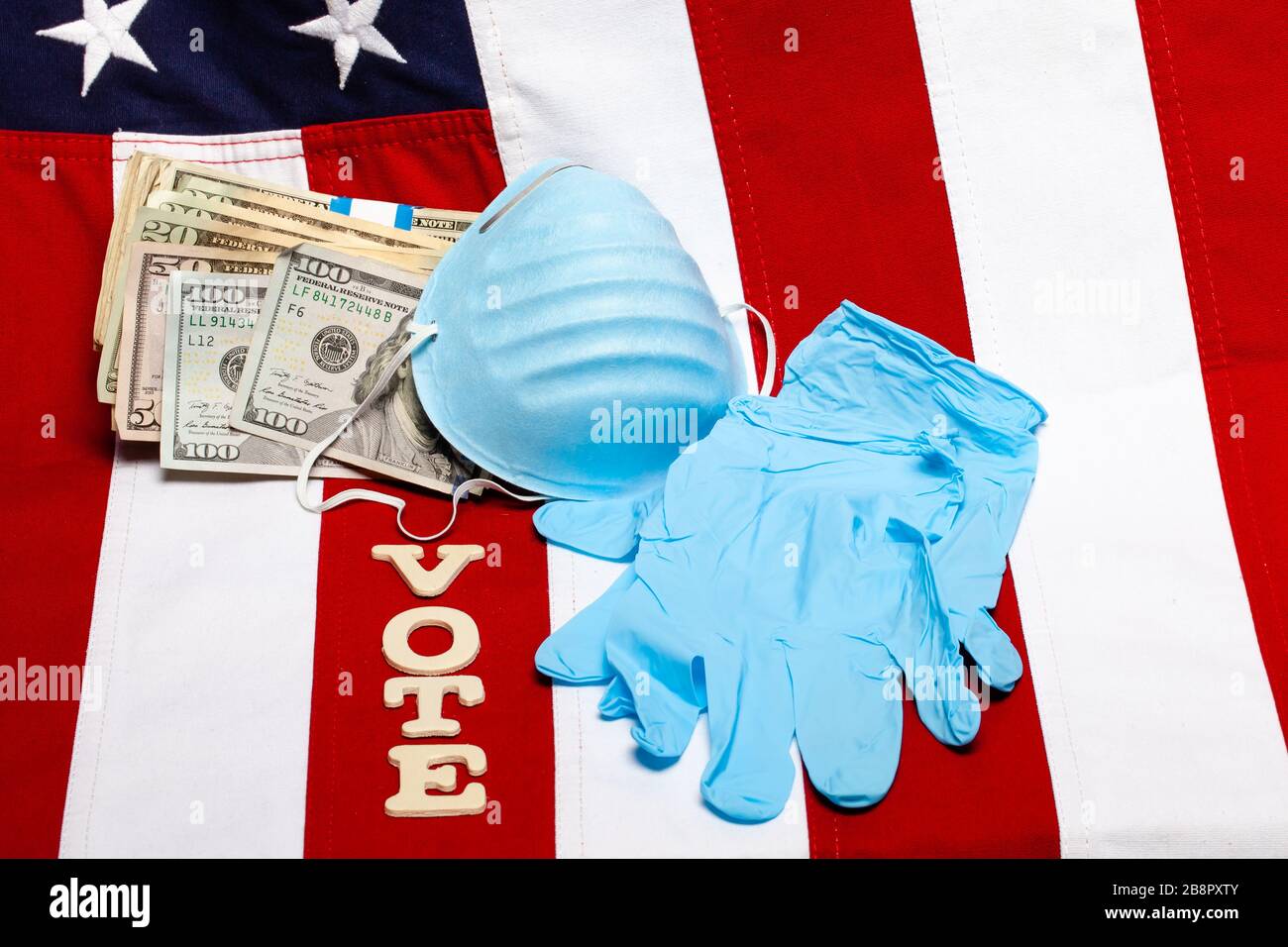 Respirator mask with cash money, gloves and the words vote in front of ...