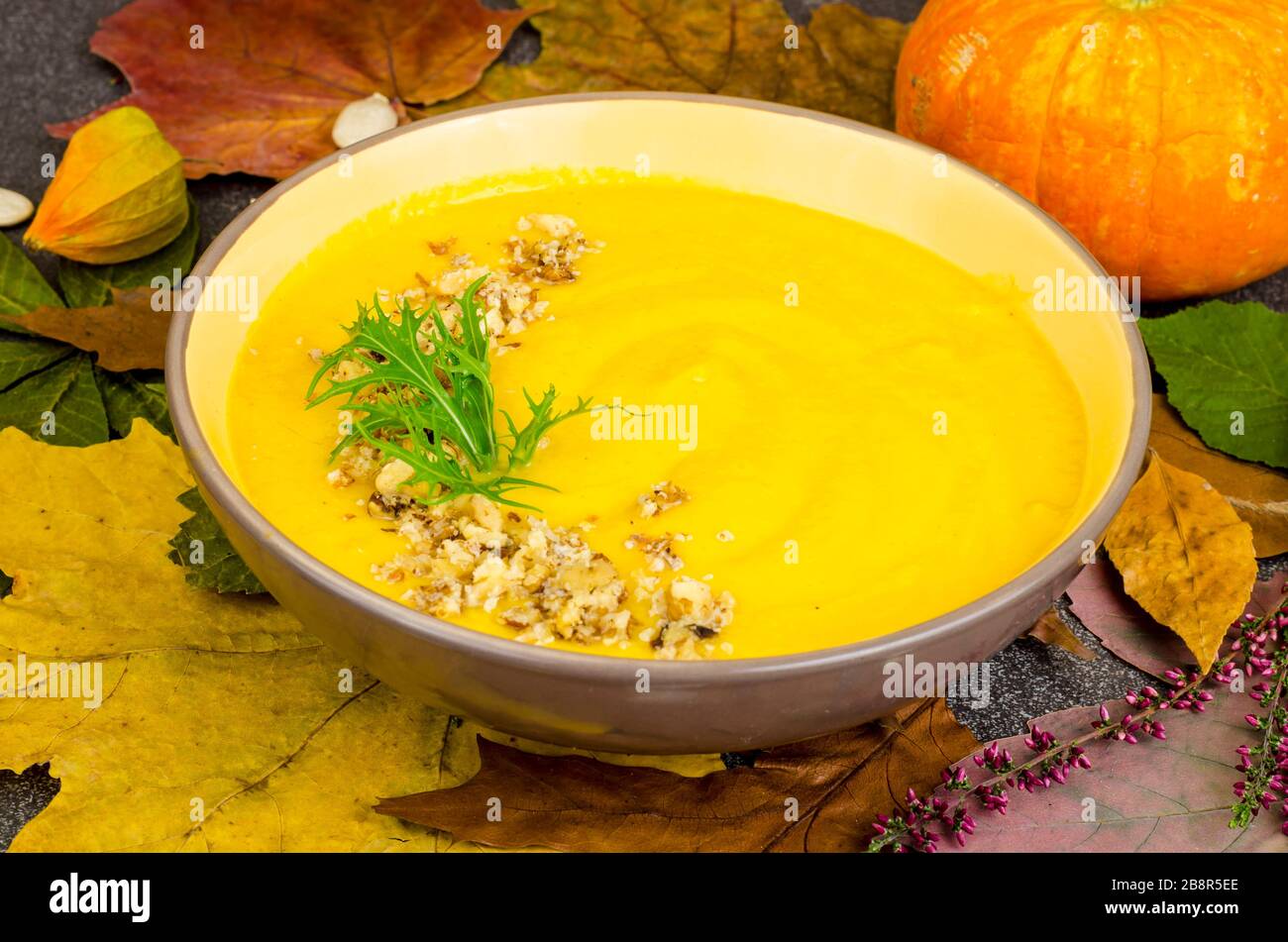 Hot pumpkin soup on background of dried autumn leaves. Studio Photo Stock Photo - Alamy