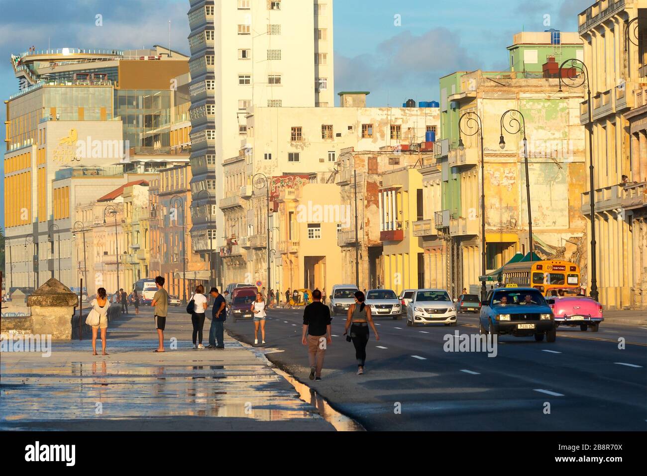 Tourists and locals walking in the Malecon Promenade, in Havana, Cuba ...