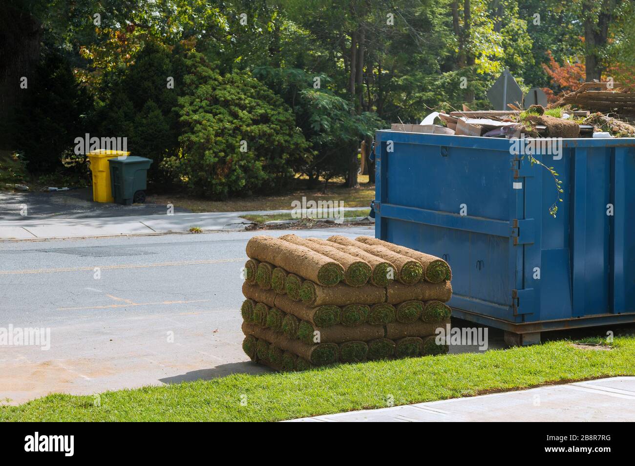 Installation of a modern landscape stacks of sod rolls for new lawn and ...
