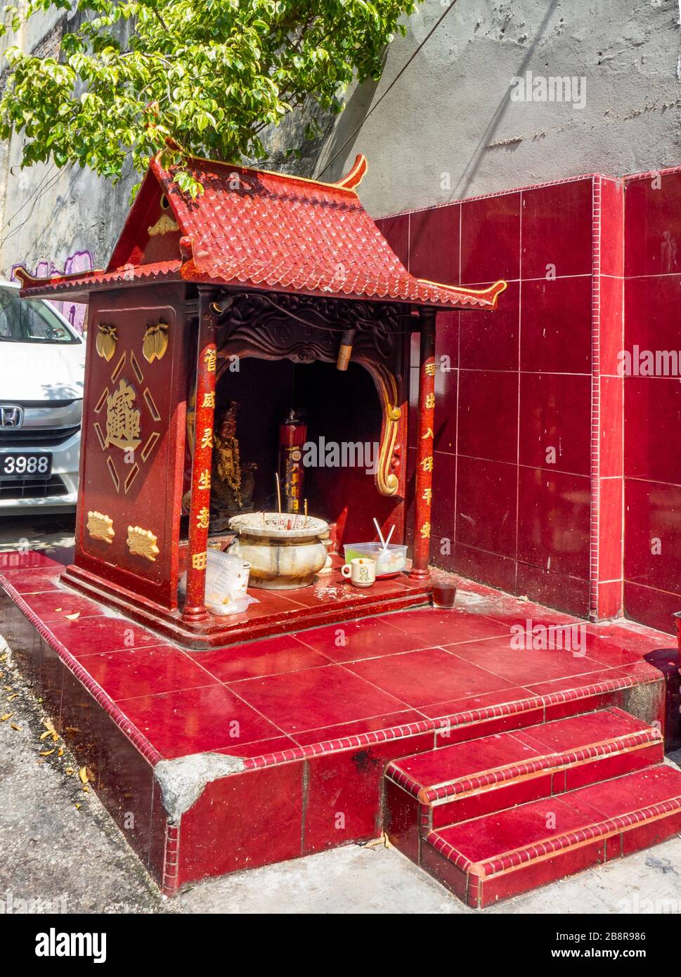 Red Buddhist shrine with offerings located in Lorong Panggung Chinatown ...