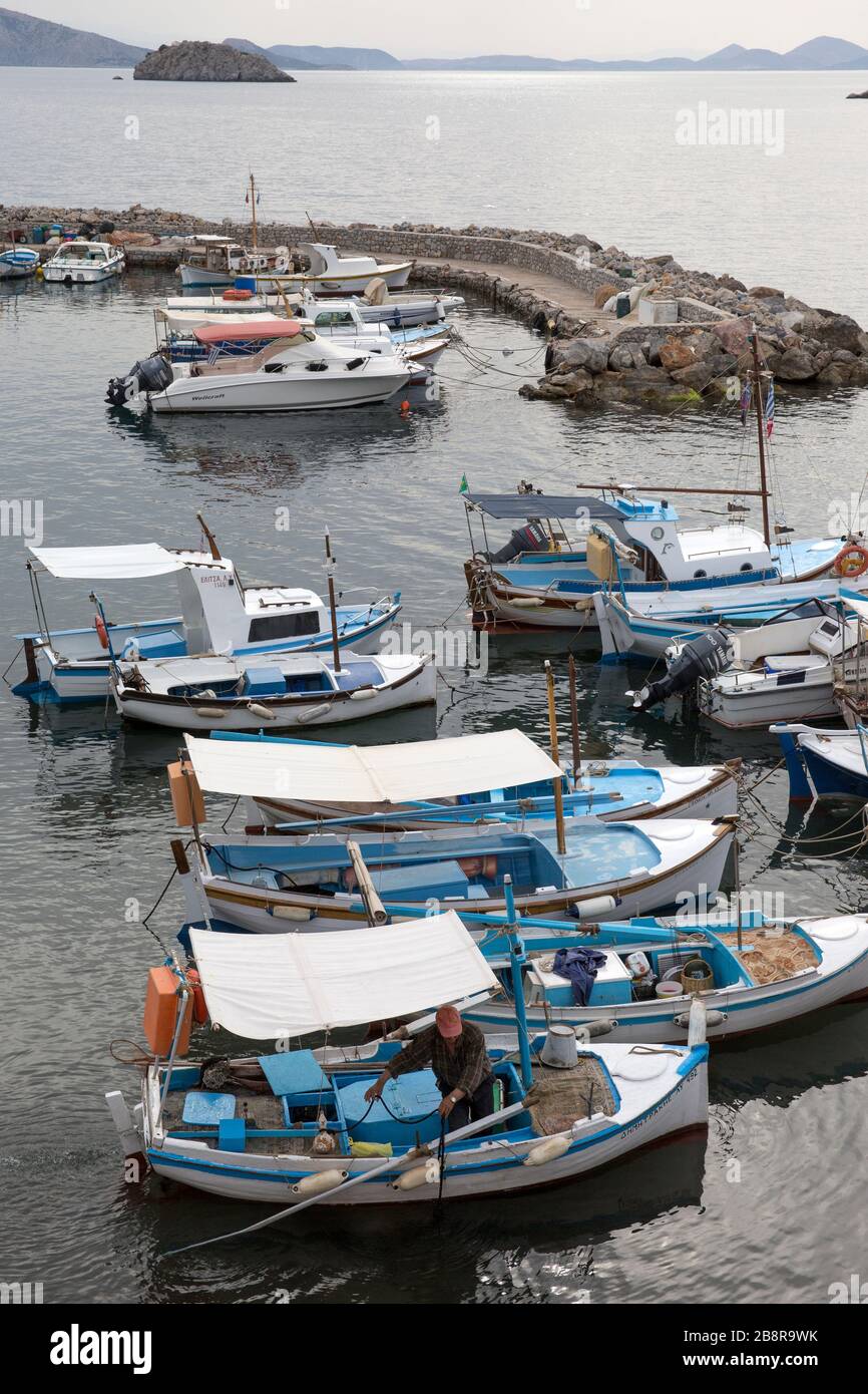 Fishing boats anchored in the Greek harbor of Kamini, Greece on the ...