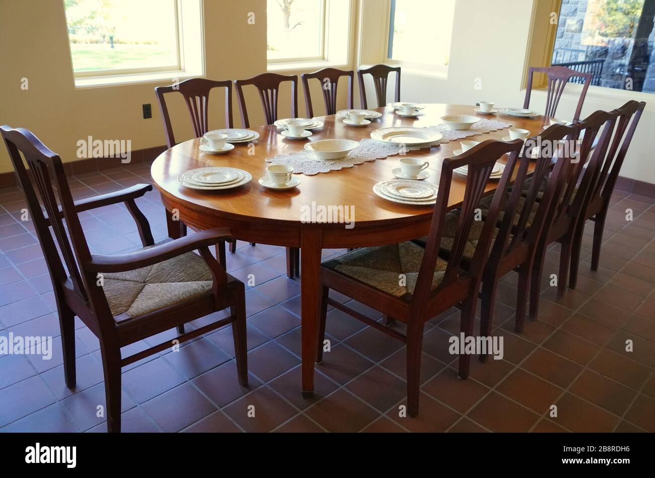 A dining table with glassware overlooking a bright window Stock Photo ...