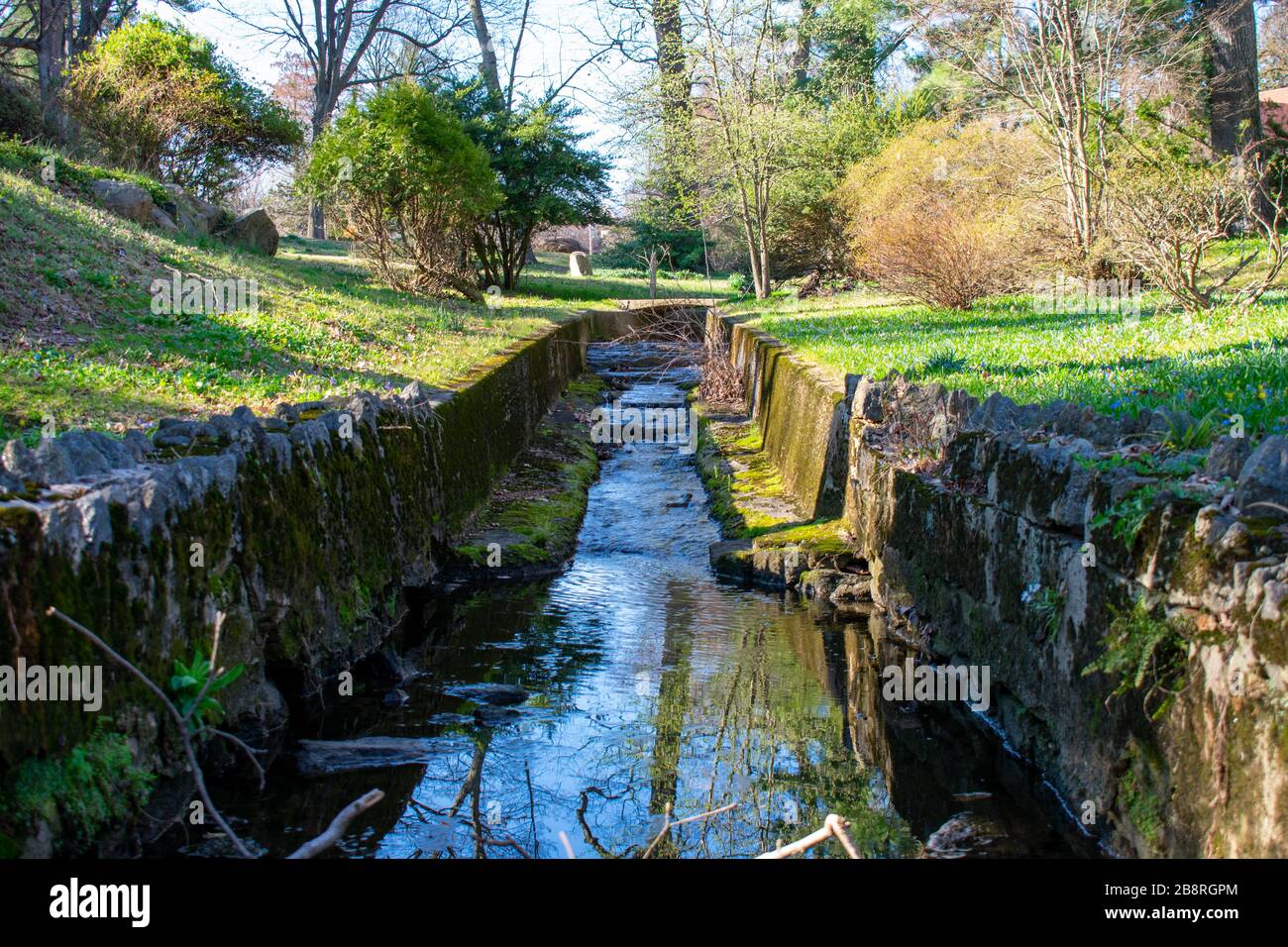 A Man Made Stream With Cobblestone Walls on Each Side Stock Photo - Alamy