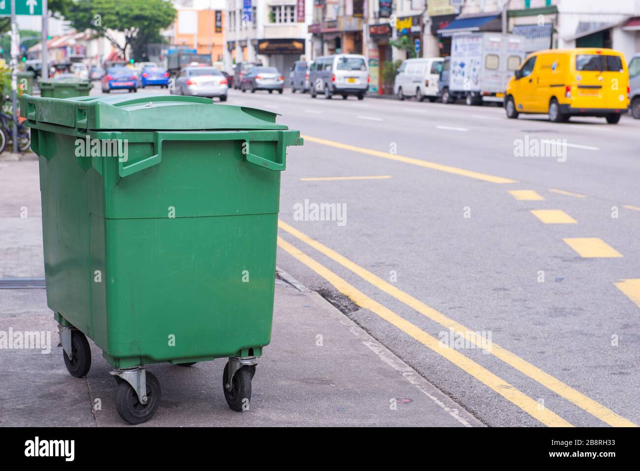 Green recycling bin container or garbage Trashcan on the street of city ...