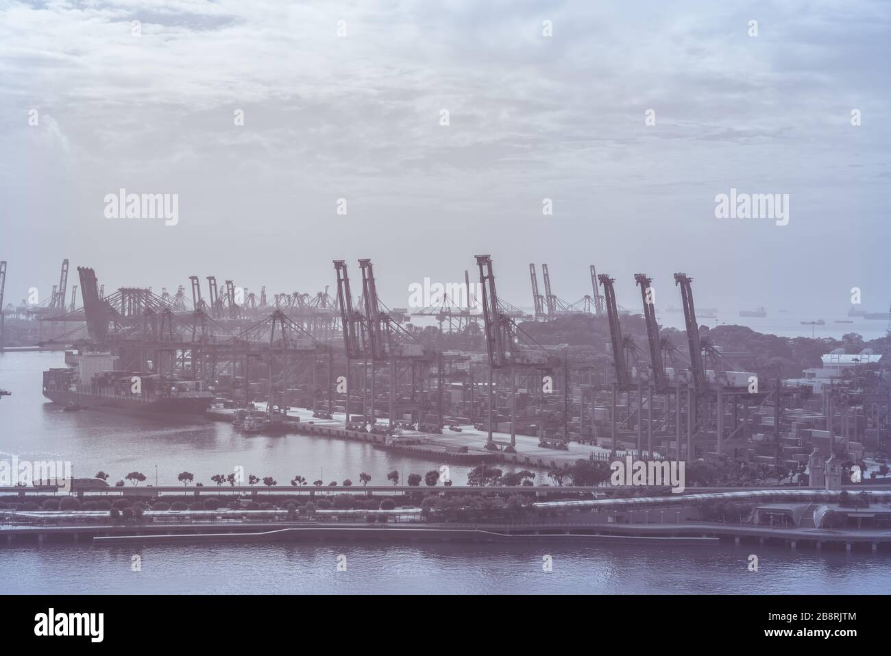 Container Cargo freight ship with working crane bridge in shipyard ...