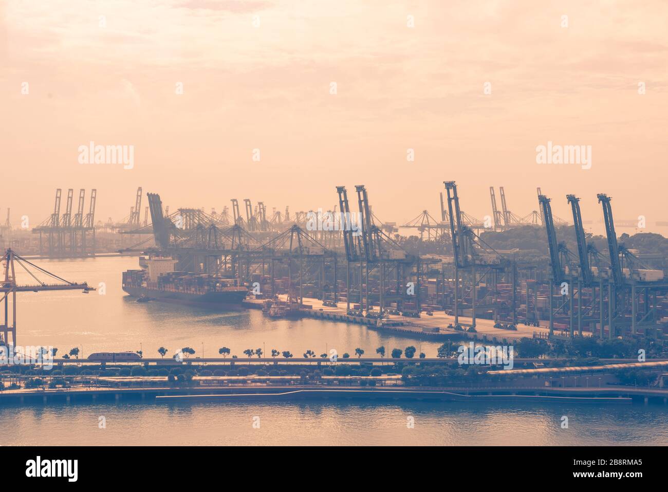 Container Cargo freight ship with working crane bridge in shipyard ...