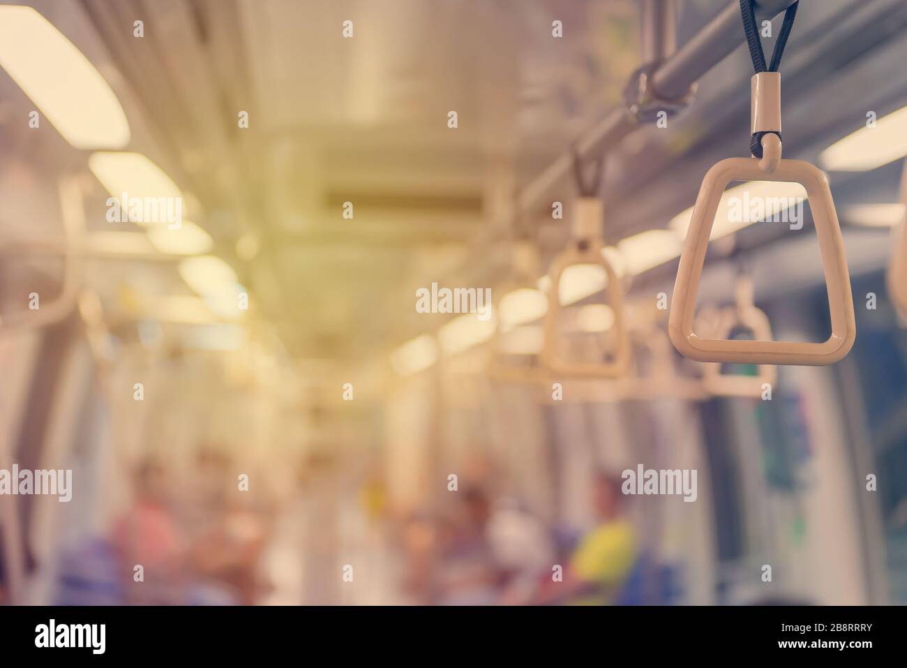 Handles on ceiling for standing passenger inside a bus Stock Photo - Alamy