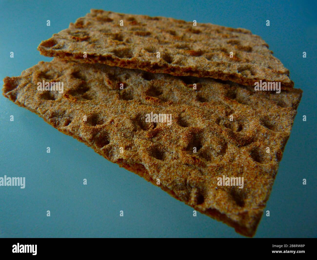 brown rustic thin rye crisp bread slice or cracker. rough textured ...