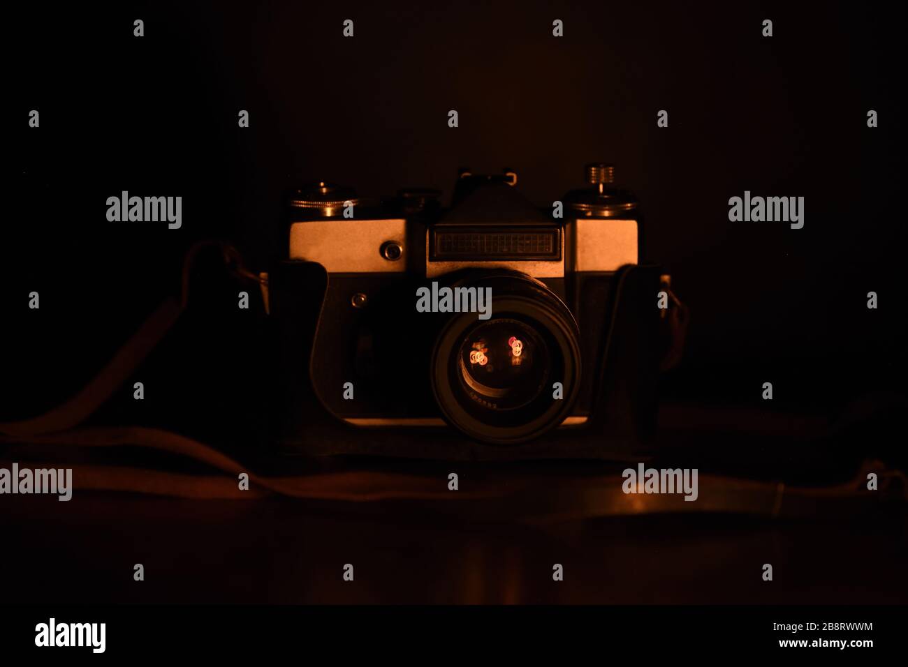 Low key image of Antique camera, camera is kept over wooden table and ...