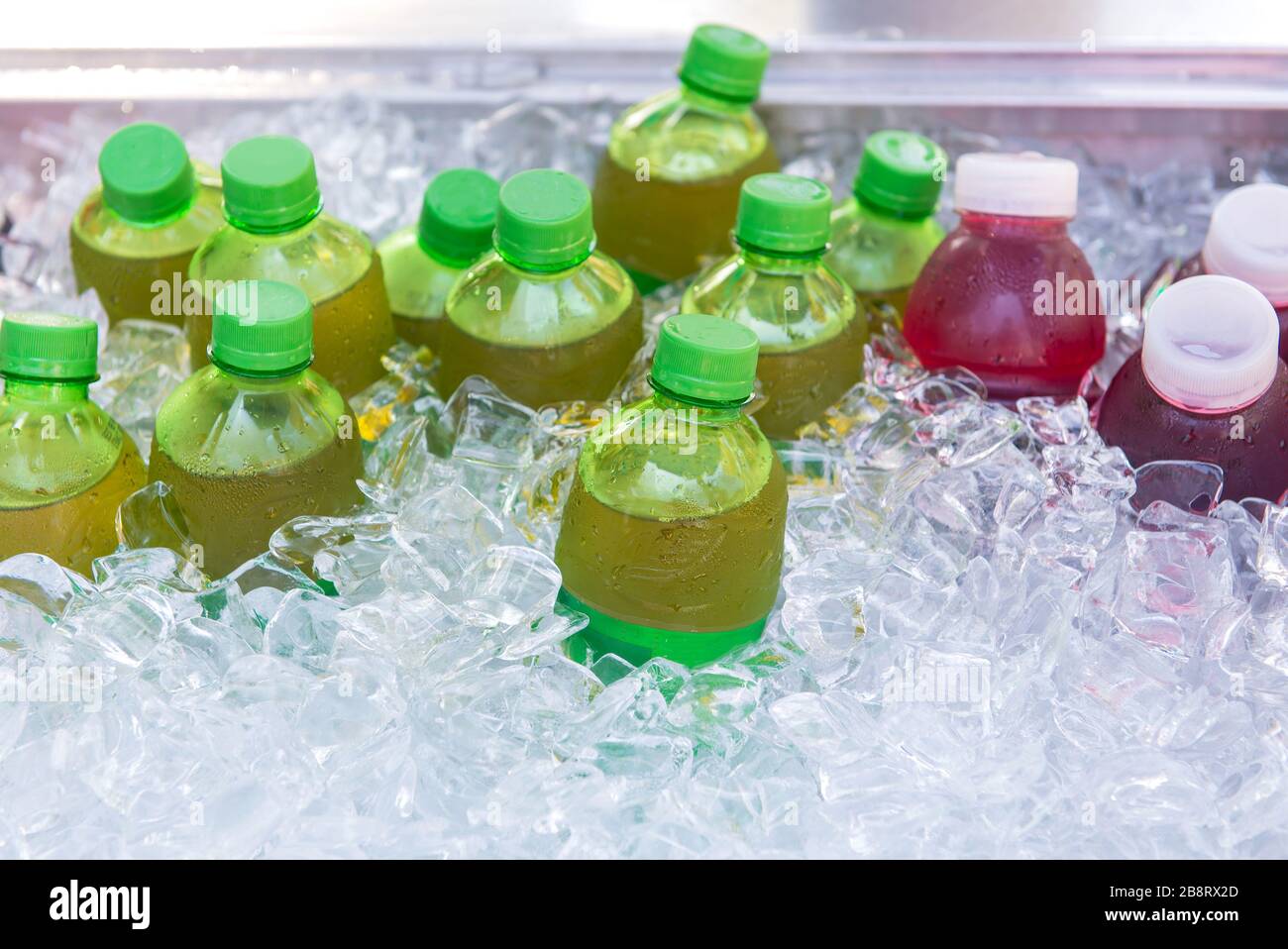 Mixed cold juice bottle in the ice box Stock Photo - Alamy