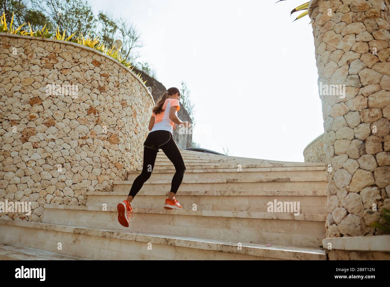 Runner athlete running on stairs. woman fitness jogging workout ...