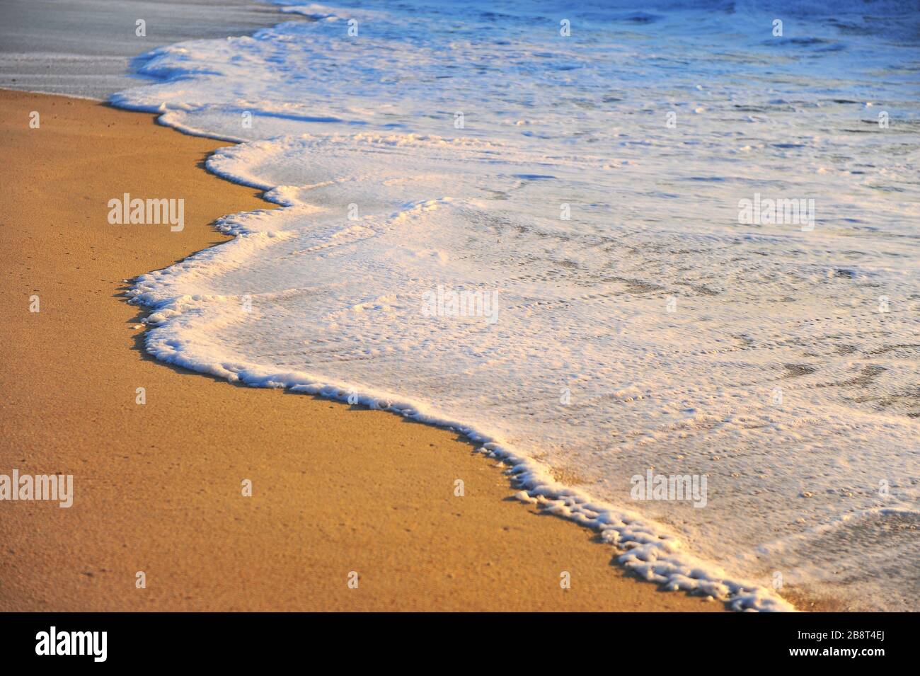 Sea waves and golden sand on the beach, summer time Stock Photo - Alamy