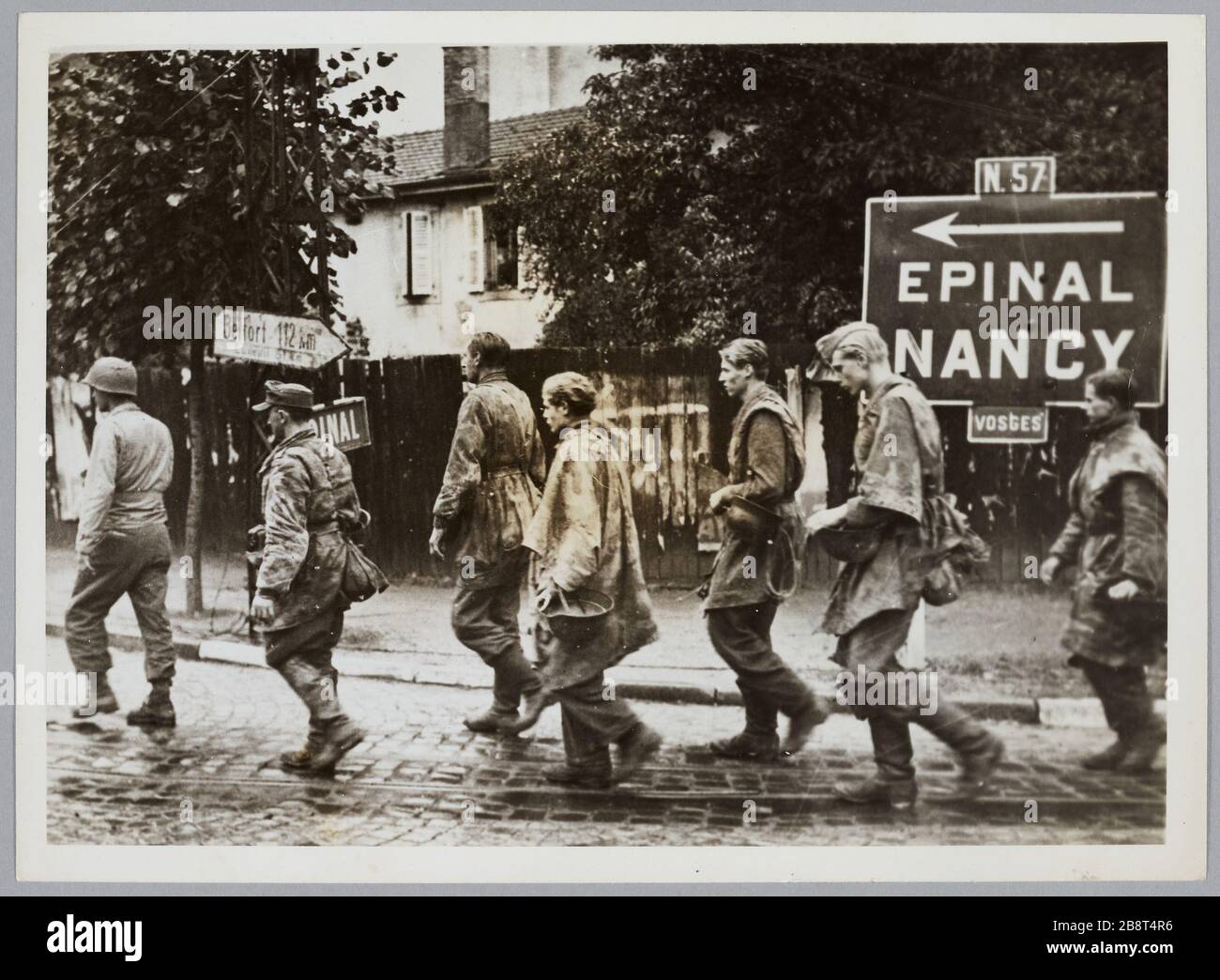 German prisoners after a US soldier at one of the entrances to the city ...