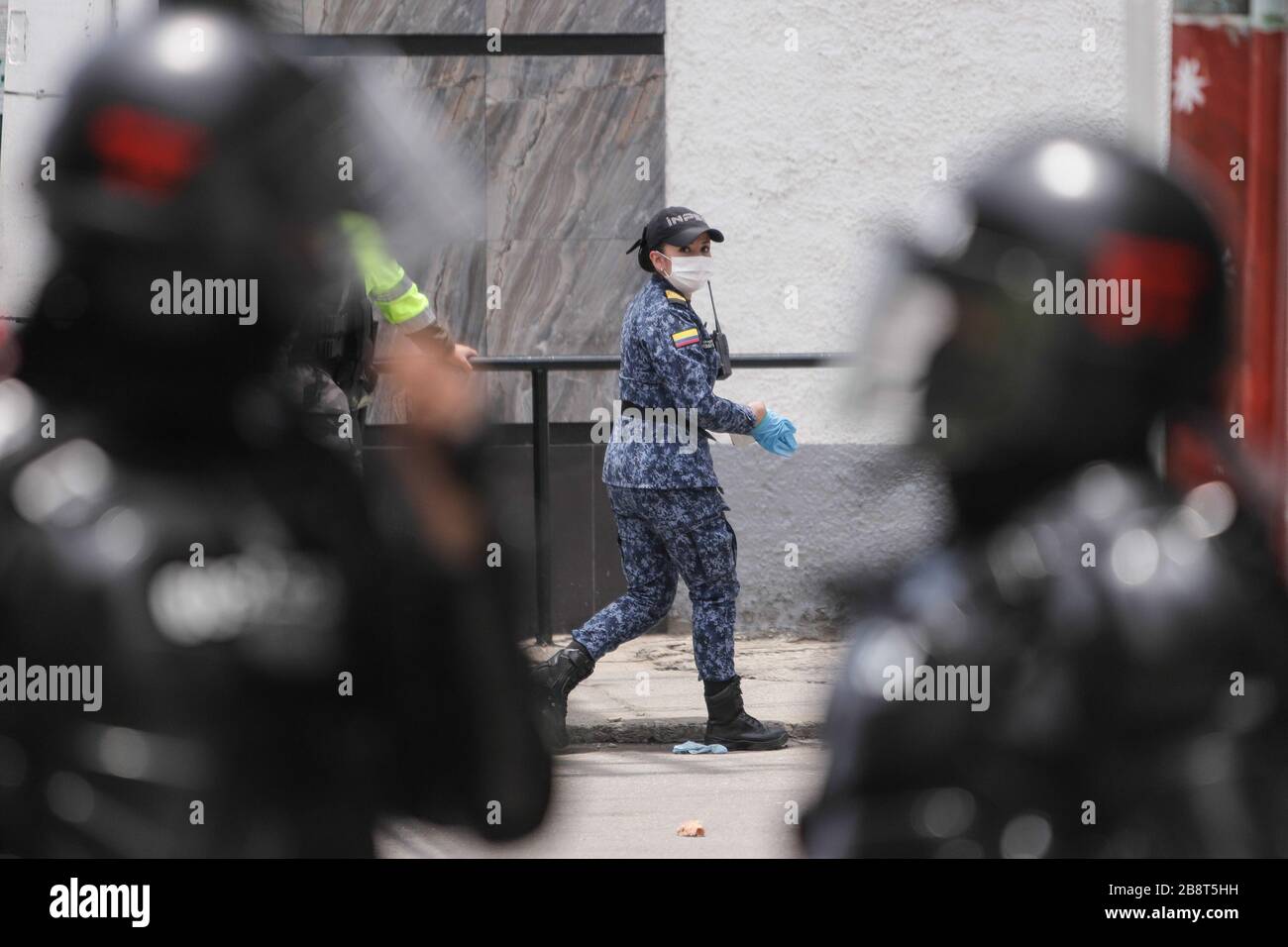 Bogota, Colombia. 22nd Mar, 2020. Policemen and prison guards stand ...