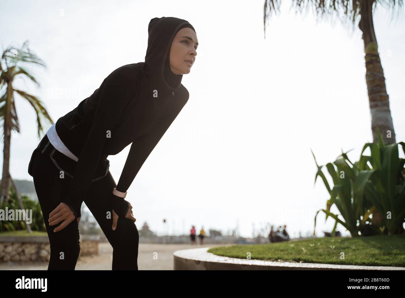 Fitness sport girl resting after intensive run, young attractive runner ...