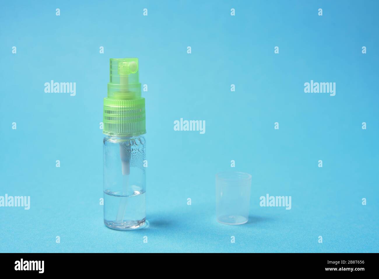 small bottle of antiseptic with a spray. microbial sanitizer. blue ...