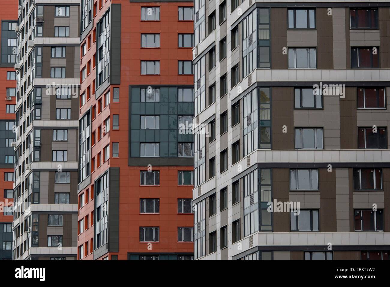 A row of modern colored multi-story buildings with close -up Windows ...