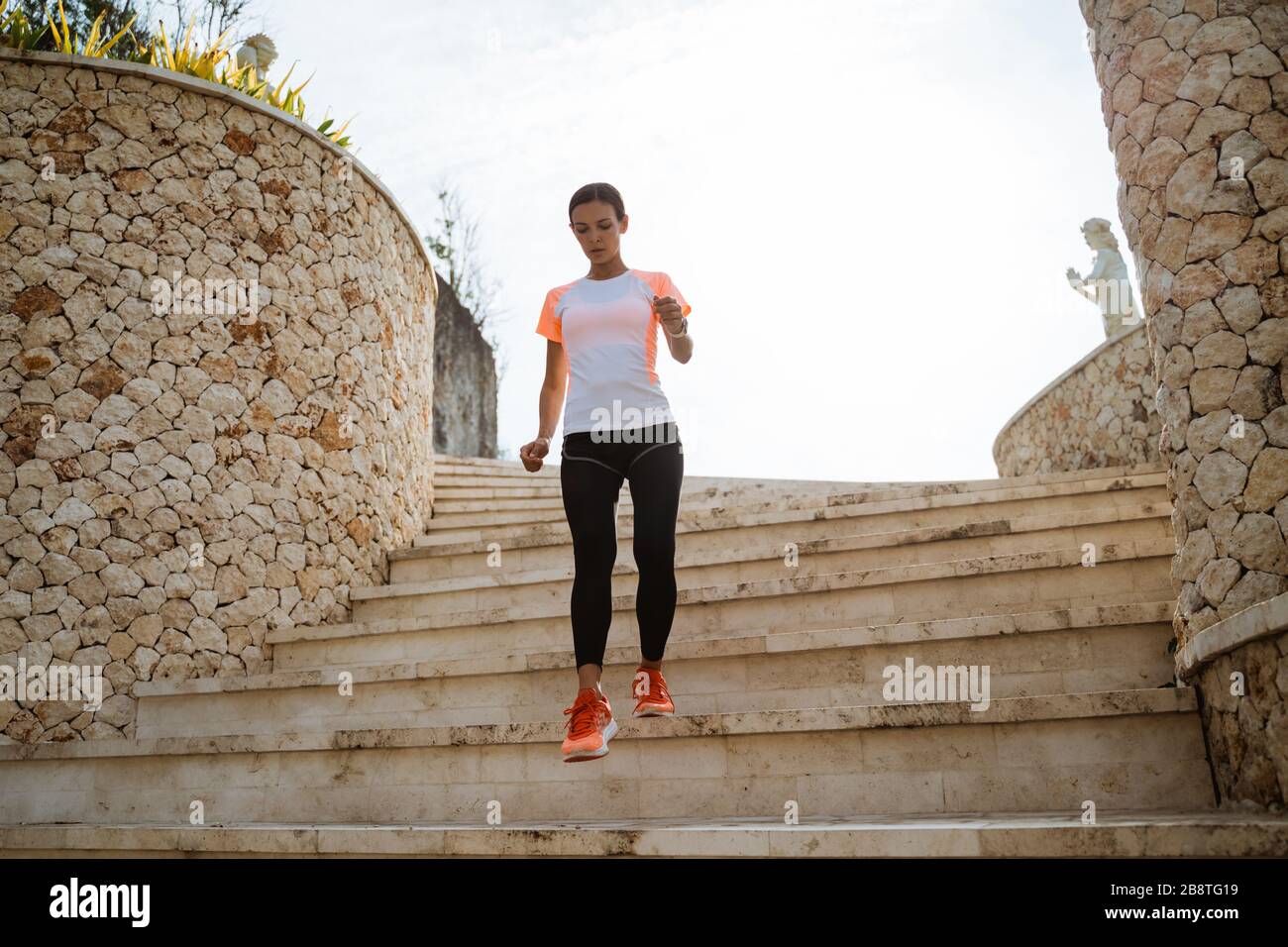 Runner athlete running on stairs. woman fitness jogging workout ...