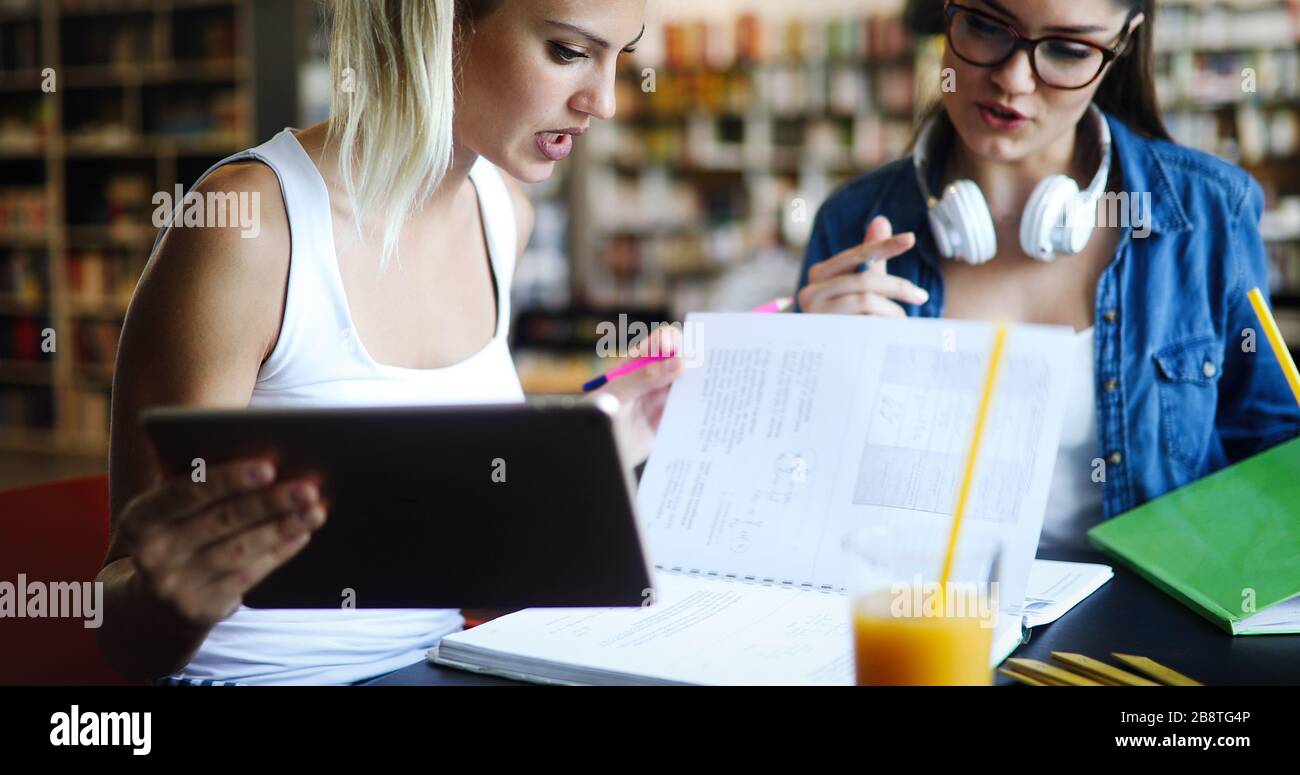 Group of college students studying in the school library Stock Photo ...
