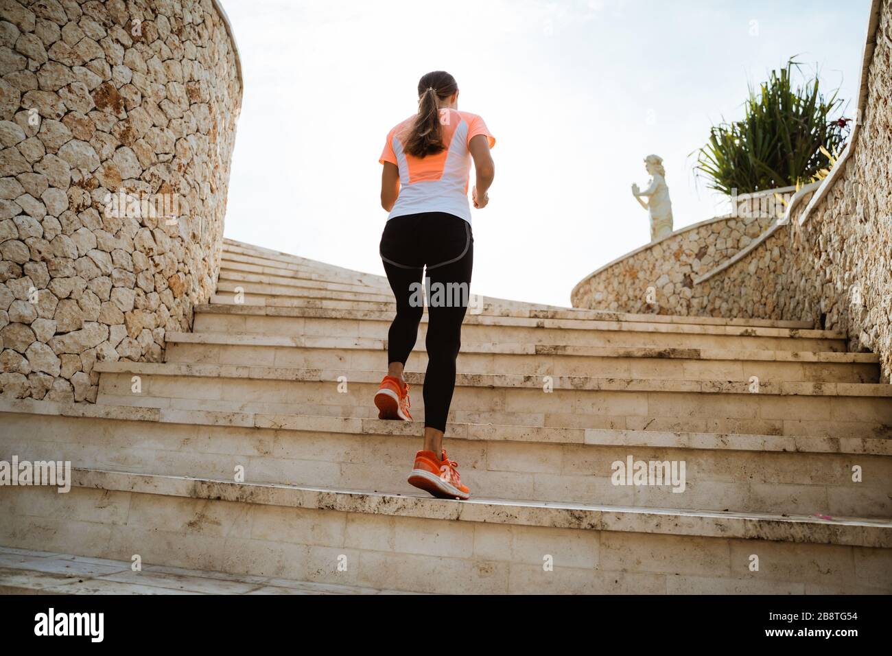 Runner athlete running on stairs. woman fitness jogging workout ...