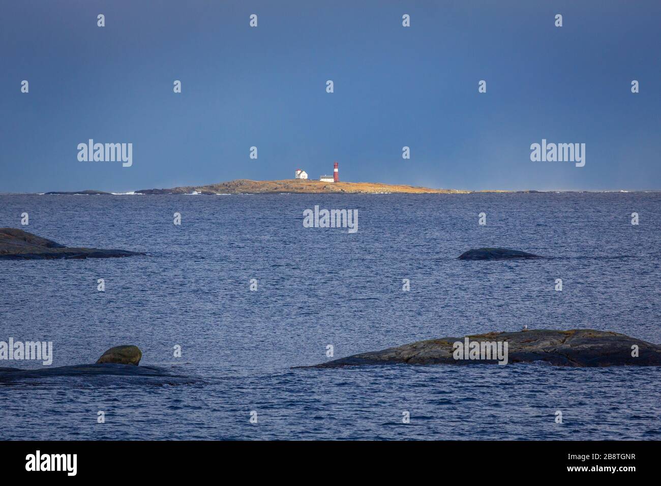 Sunbeam and rainbow over the lighthouse between Torvik and Ålesund on ...
