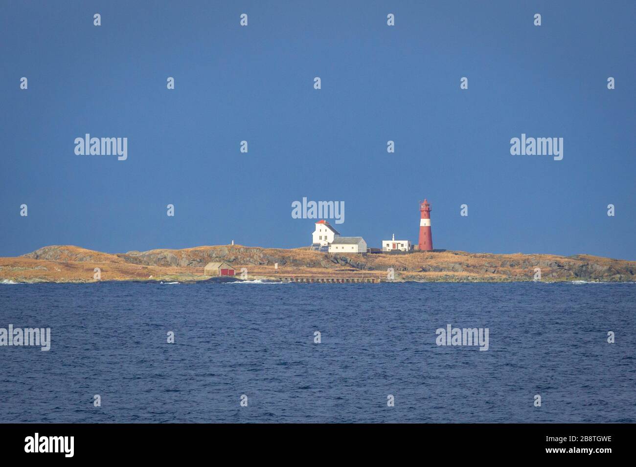 Sunbeam and rainbow over the lighthouse between Torvik and Ålesund on ...