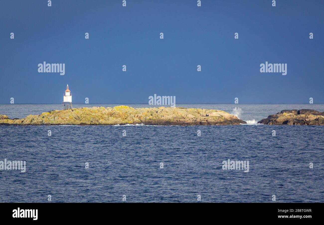 Sunbeam and rainbow over the lighthouse between Torvik and Ålesund on ...