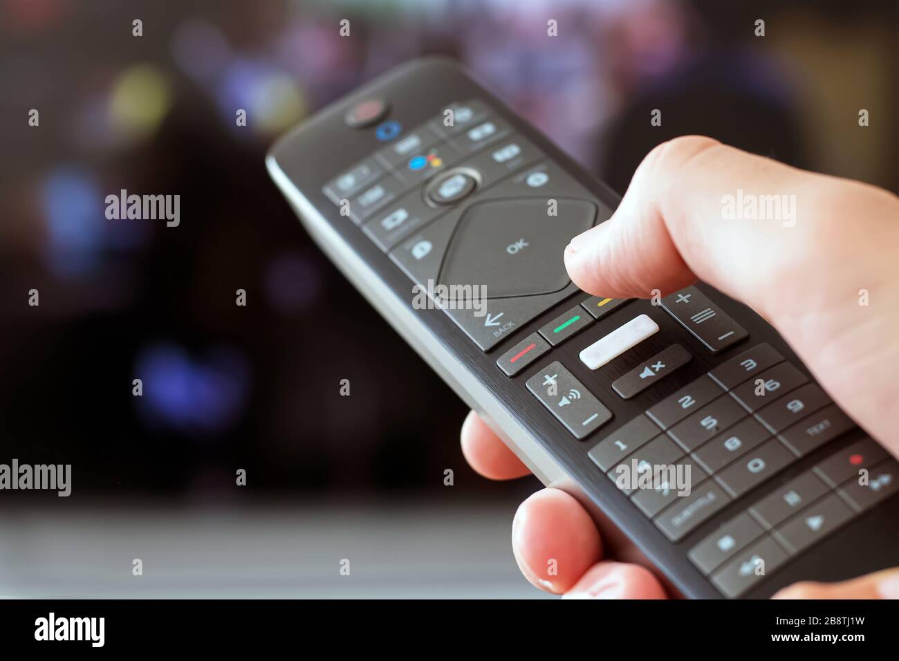 Hand holding a remote control close-up tunring on TV Stock Photo - Alamy