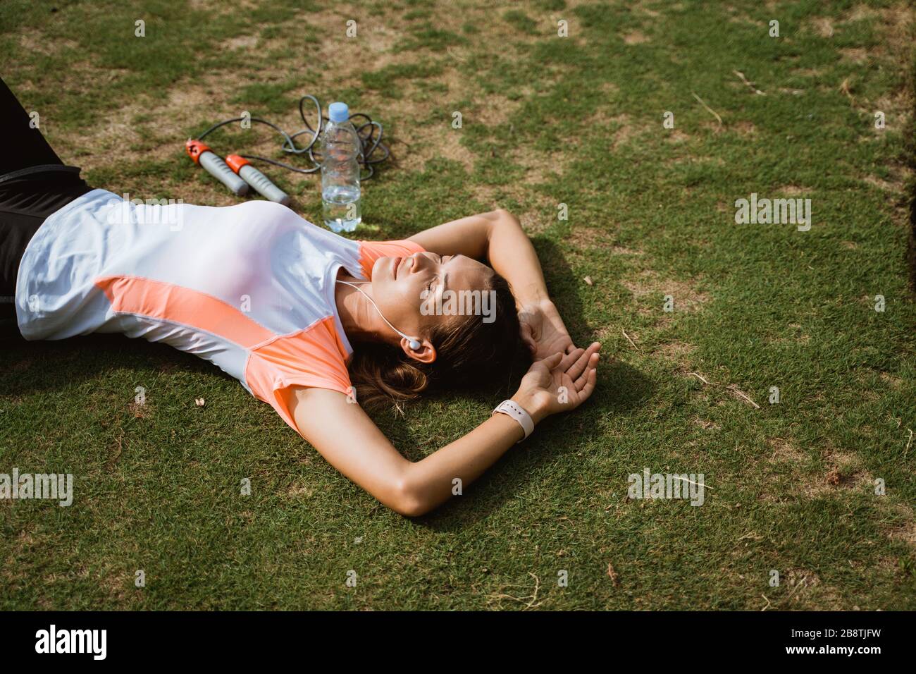 Fitness sport girl resting after intensive run, young attractive runner ...