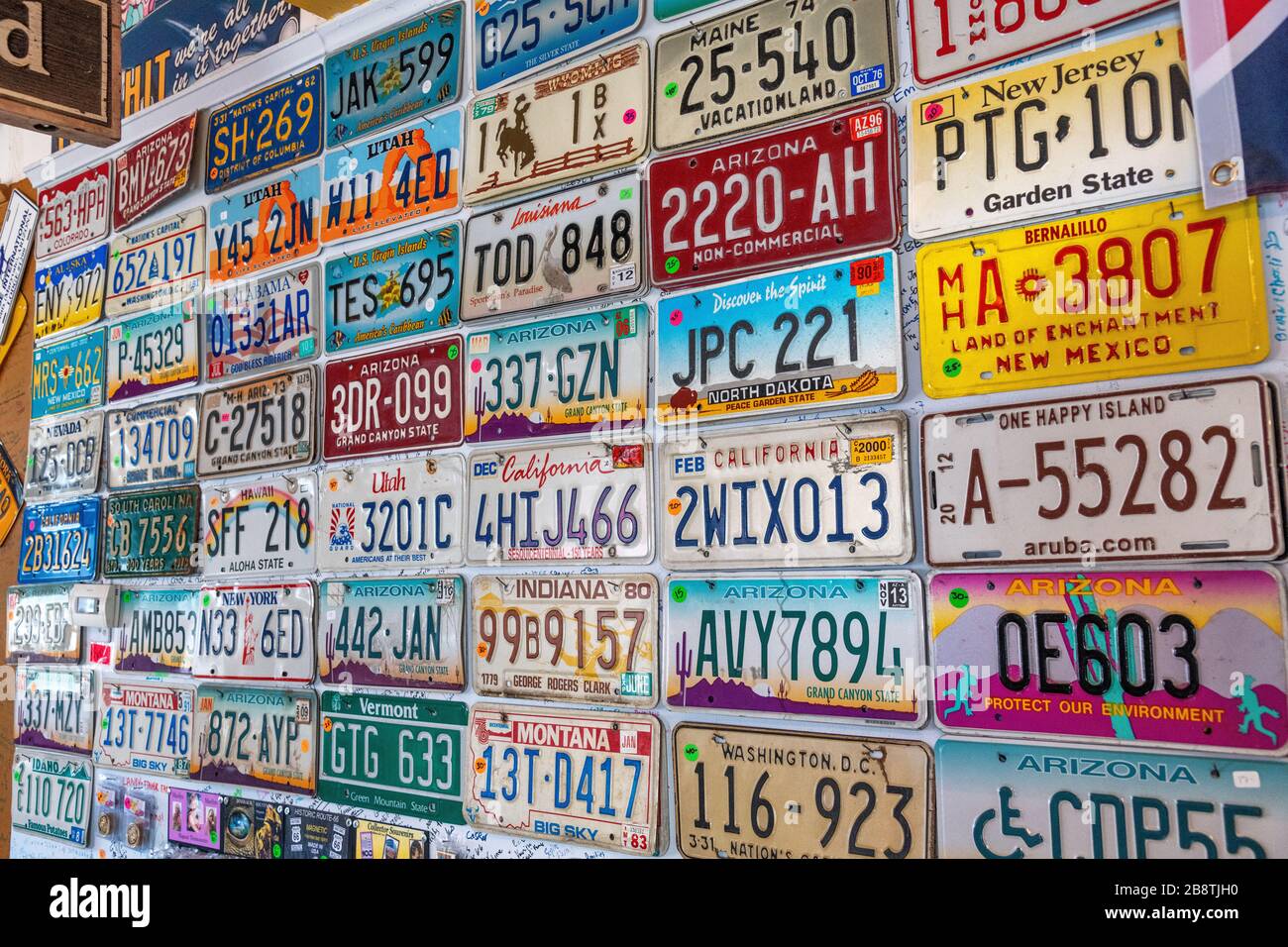 SELIGMAN, AZ - JUNE 29, 2018: Old car plates lined on a wall. Seligman ...