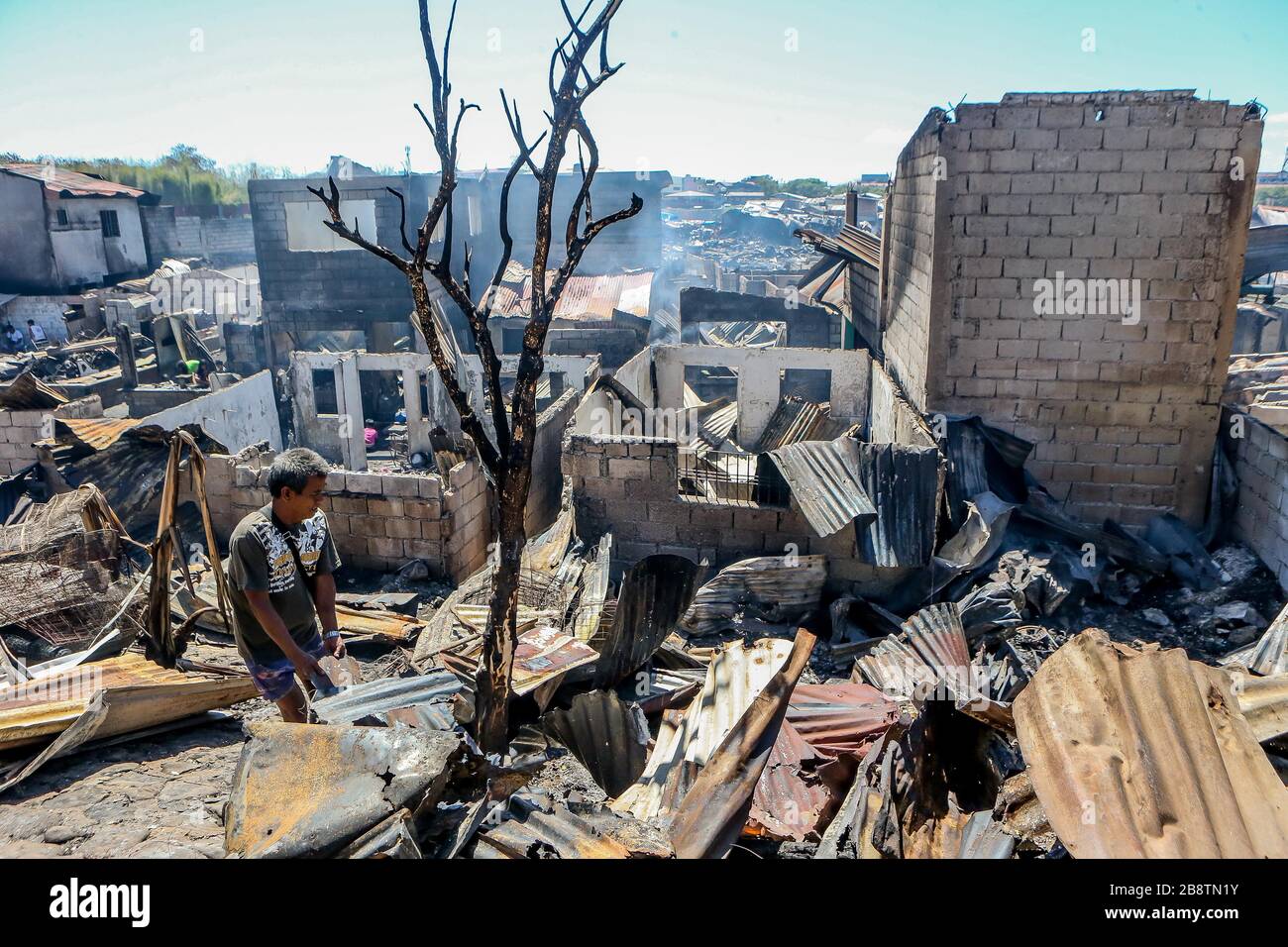 Bacoor City, Philippines. 23rd Mar, 2020. A man searches for his ...