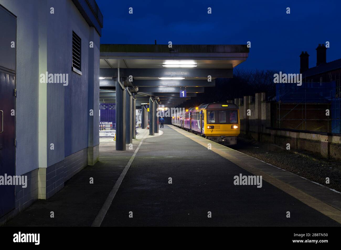 Northern rail class 142 pacer train + class 150 sprinter at Blackburn railway station at dusk ...