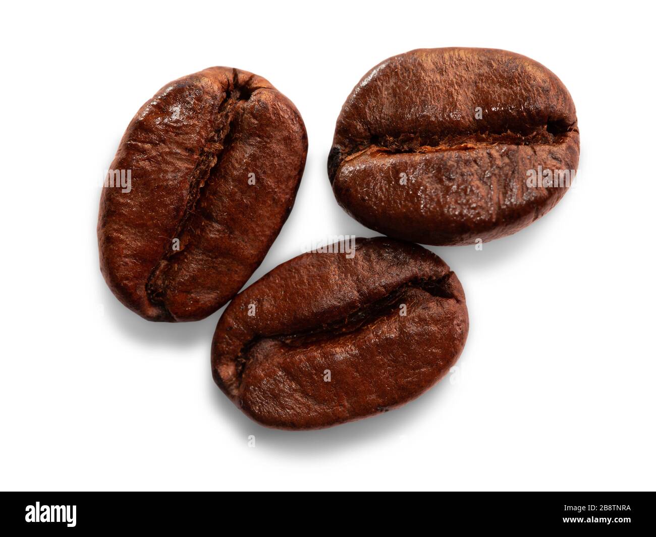Close up three roasted texture of coffee beans isolated on white ...