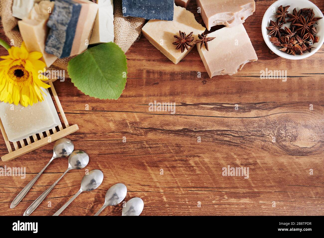 Soap making background: wooden table with measuring spoons, anise ...