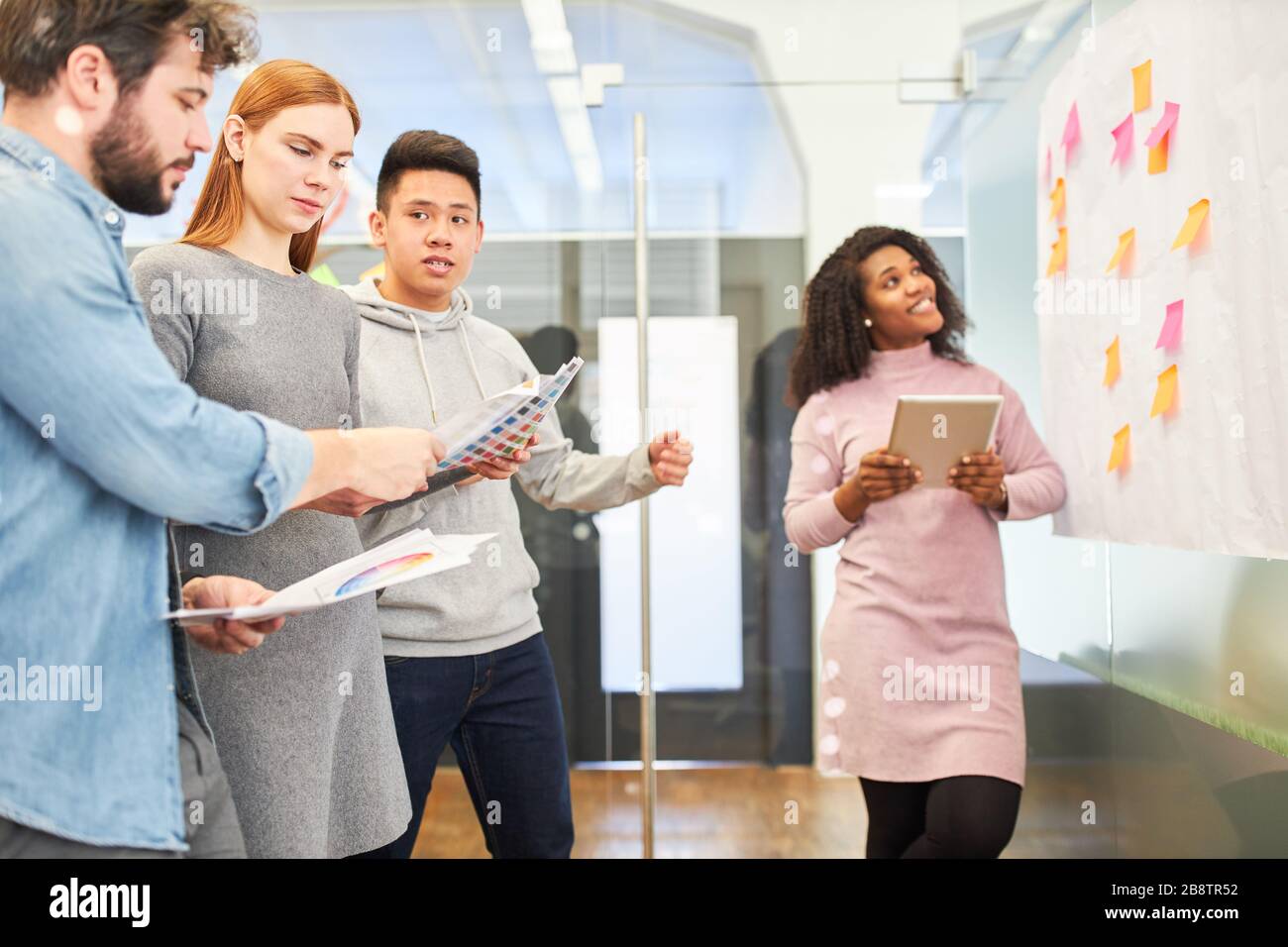 Graphic designers and web developers in the workshop discuss color ...