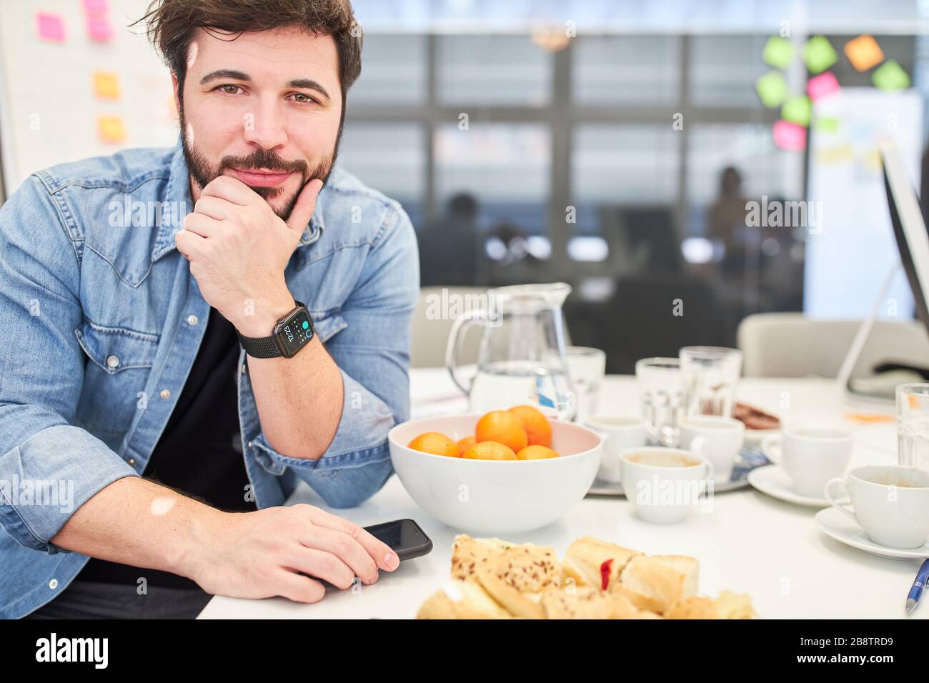Thoughtful business man in a coffee break in the office with his hand ...