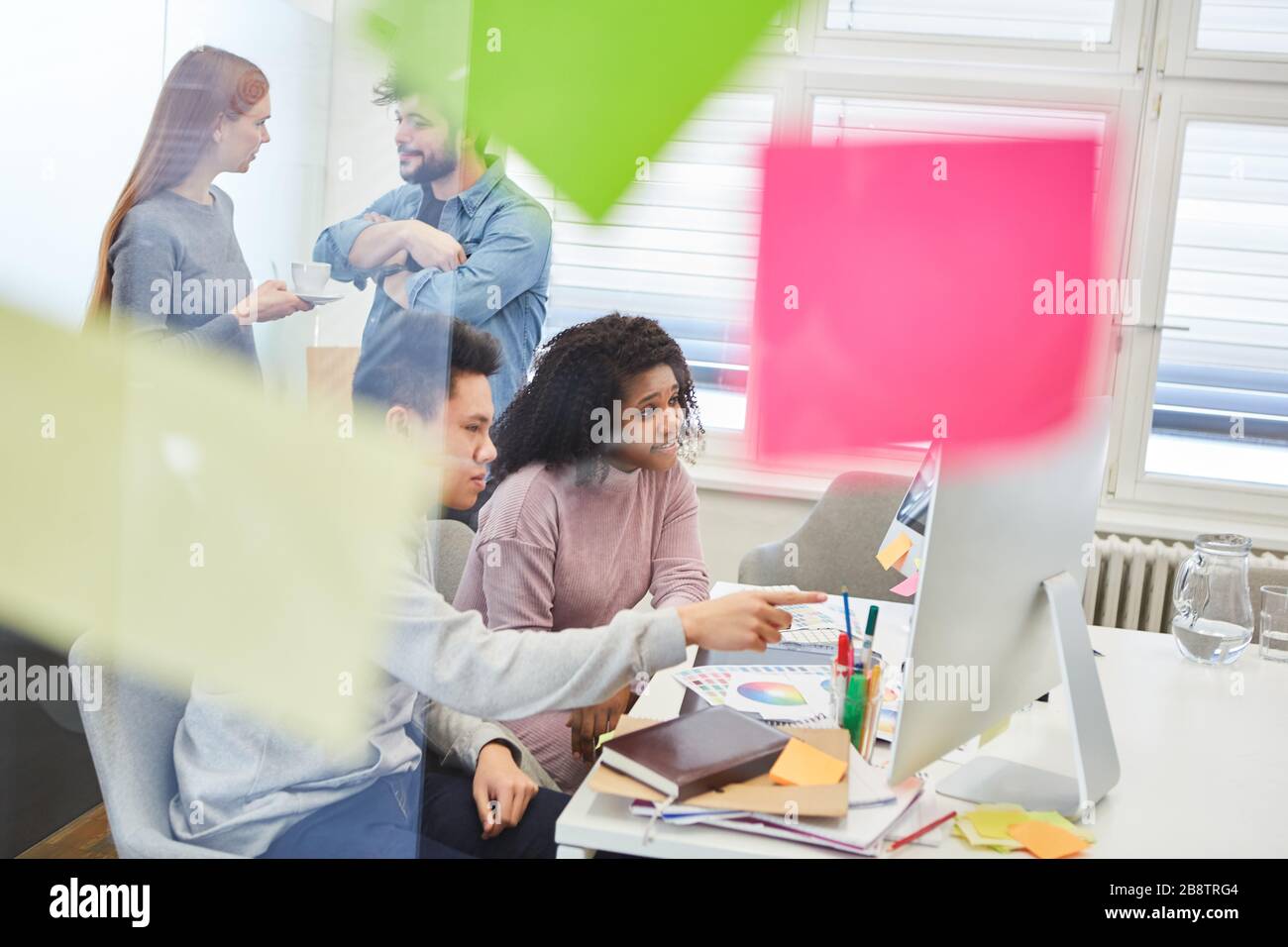 Web designers and developers work together on a PC in the Internet ...