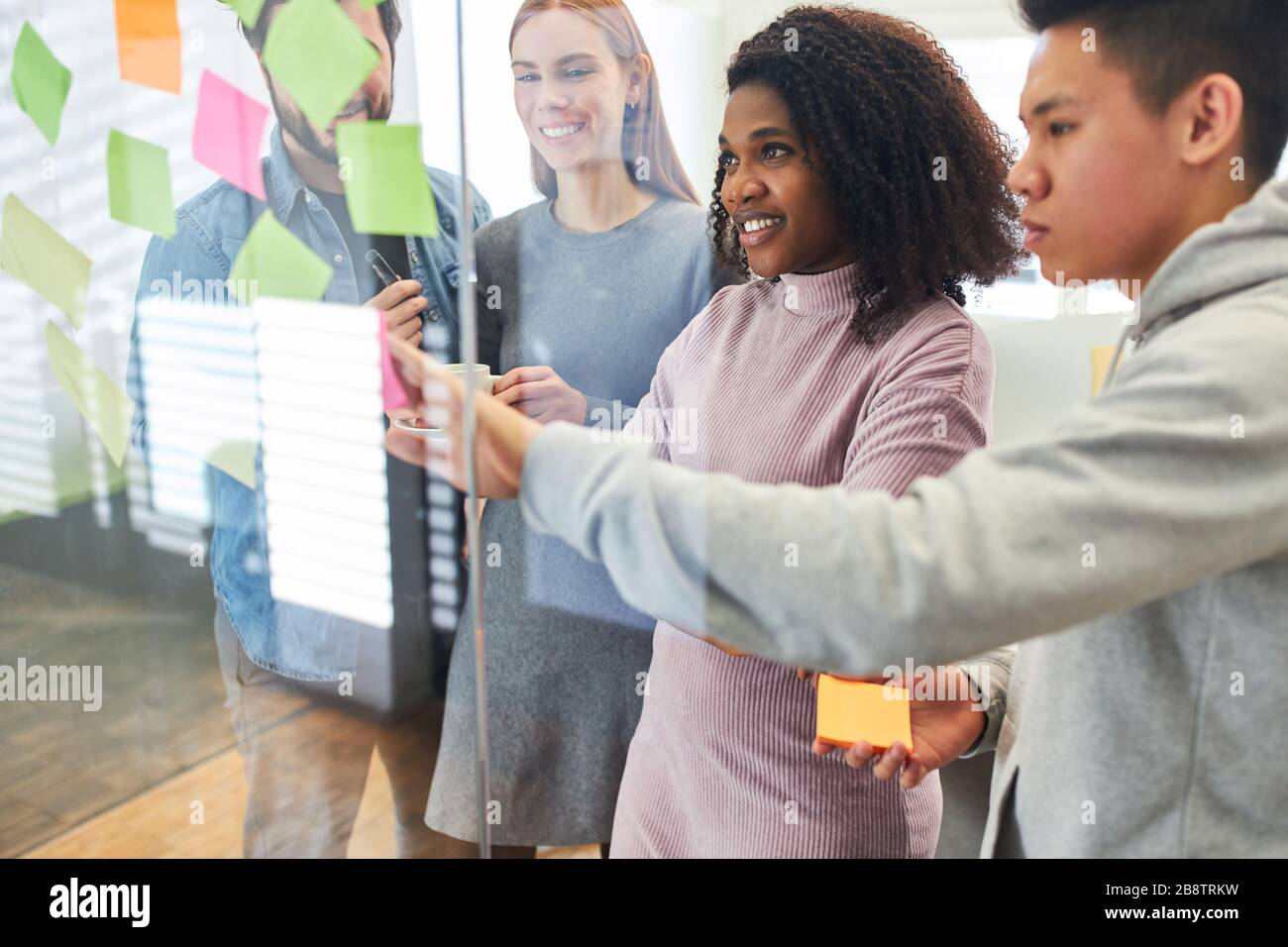 Multicultural start-up team brainstorming in a creative workshop Stock ...