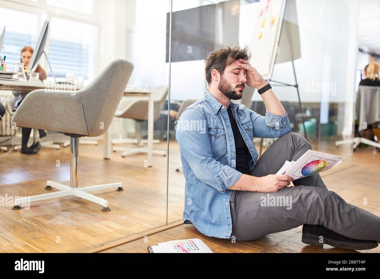 Graphic designer with a headache or stress when choosing a color for a ...