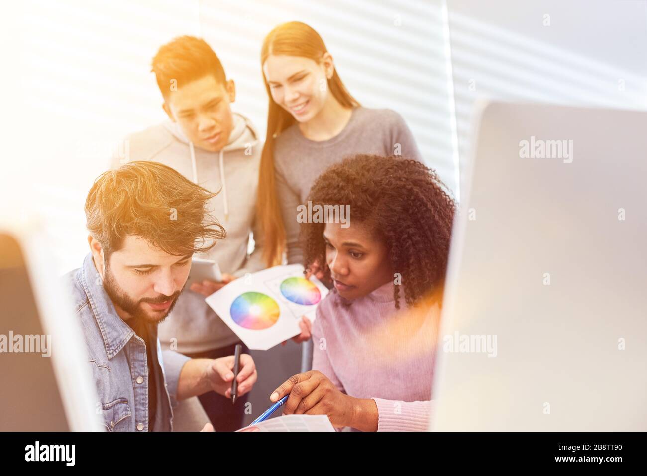 Team of graphic designers plans color design together in the office at ...