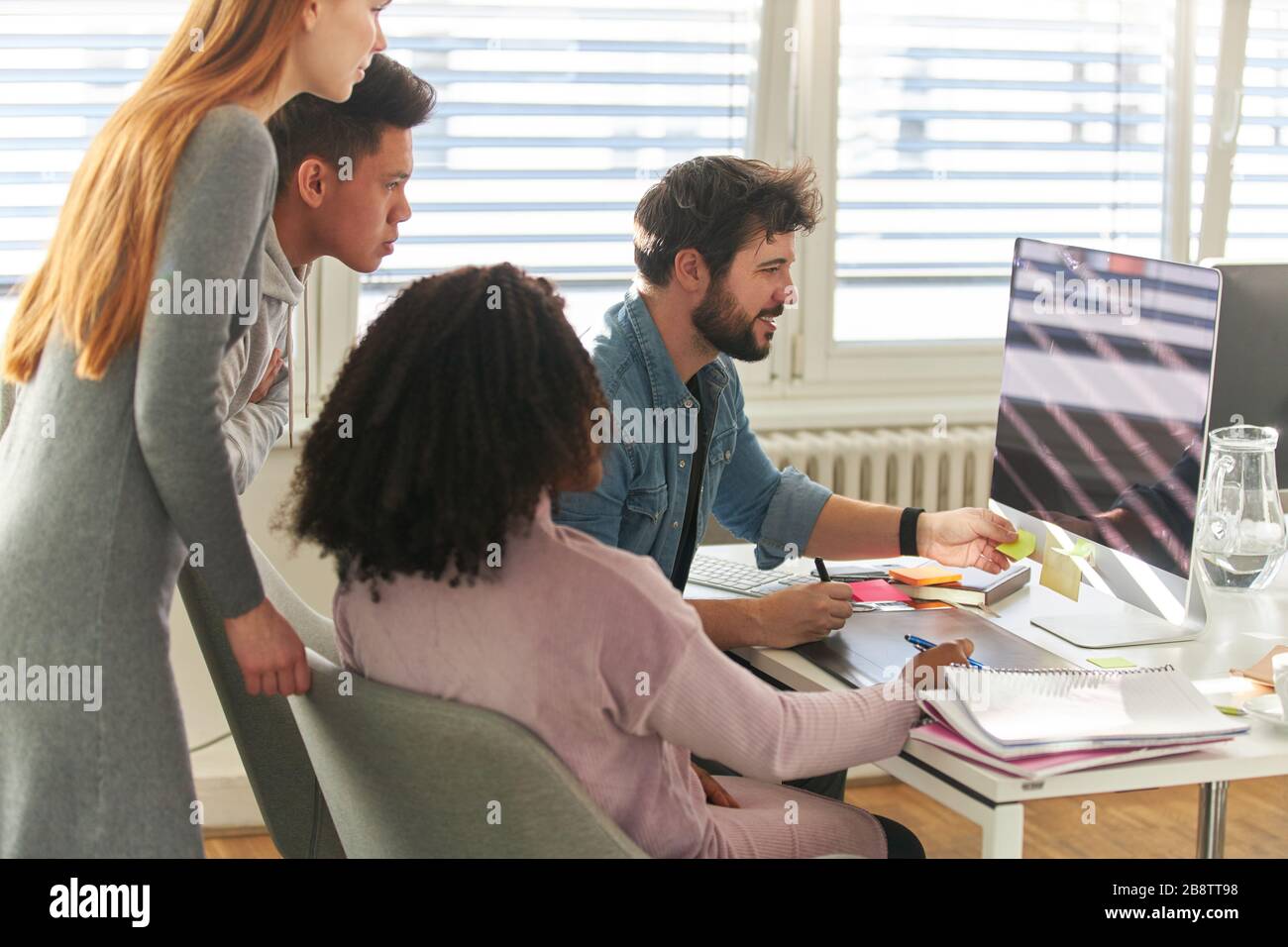 Web designer and graphic designer team on PC during project development ...