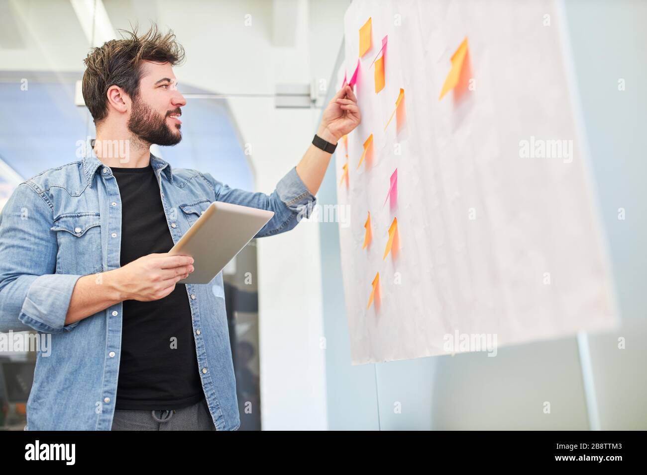 Business man evaluating ideas while brainstorming with sticky notes ...