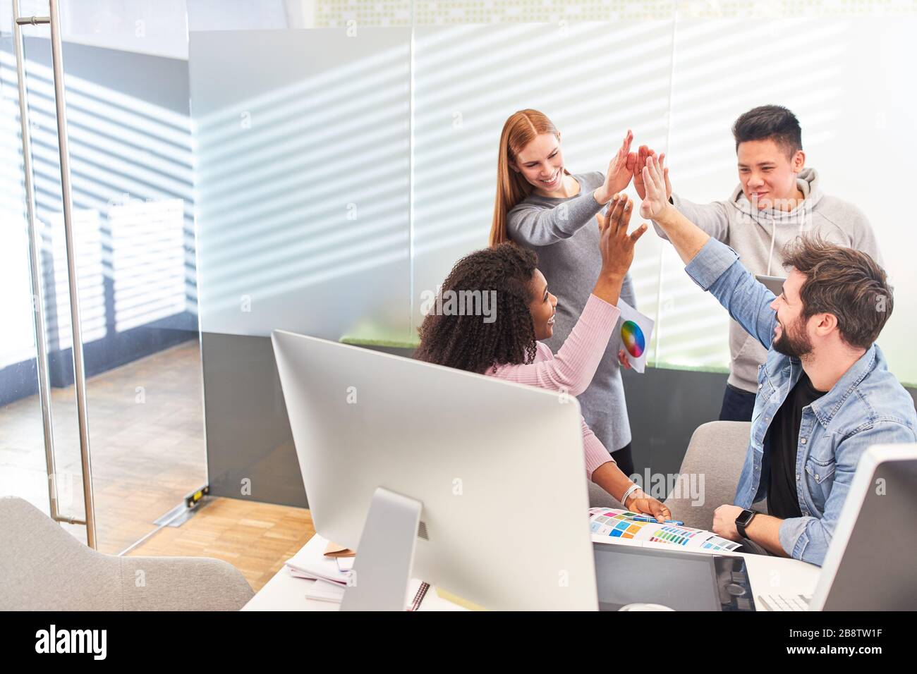 Successful start-up team gives itself a high five for team spirit Stock ...