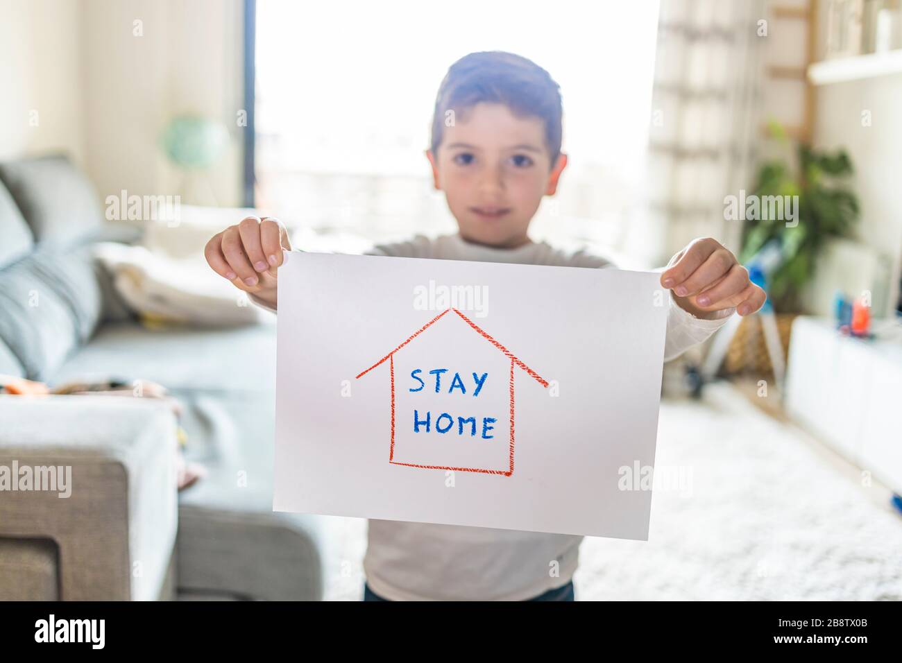 Little kid with Stay Home draw. Coronavirus concept Stock Photo - Alamy